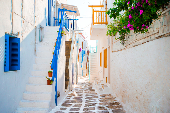 The narrow streets of greek island with blue balconies, stairs and ...