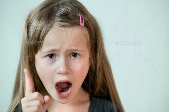 Close up portrait of angry shouting child girl looking aggressively in ...