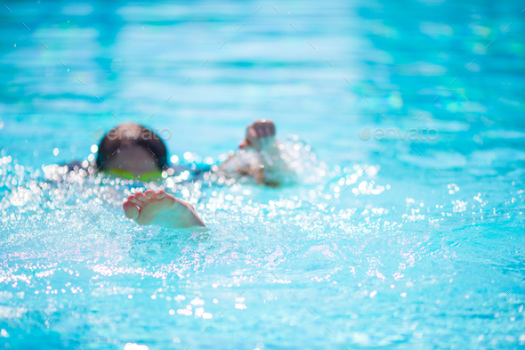 Happy little girl having fun in outdoor swimming pool Stock Photo by ...