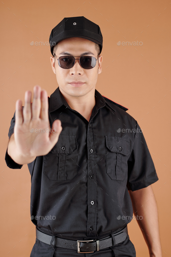 Security Guard Making Stop Gesture Stock Photo by DragonImages | PhotoDune