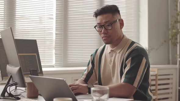 Portrait of Asian IT Specialist at Workplace, Stock Footage | VideoHive