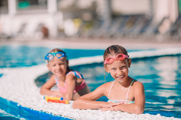 Adorable little girls in outdoor swimming pool Stock Photo by ...