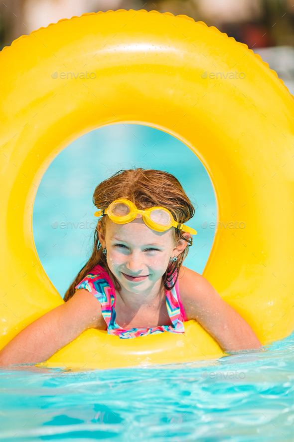 Adorable little girl swimming at outdoor swimming pool Stock Photo by ...