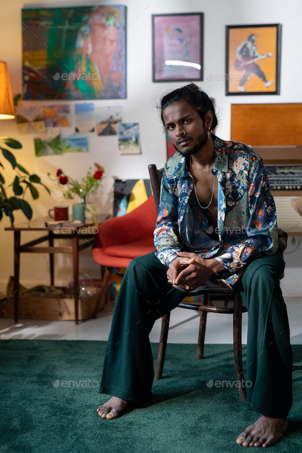 Young relaxed man sitting on chair in modern art or design studio Stock ...