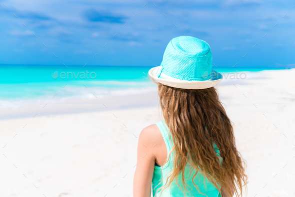 Rear view of little girl at beach on summer vacation Stock Photo by ...