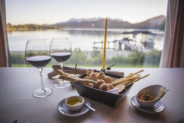 Table set up for dinner at a fine dining restaurant with a glass of red ...
