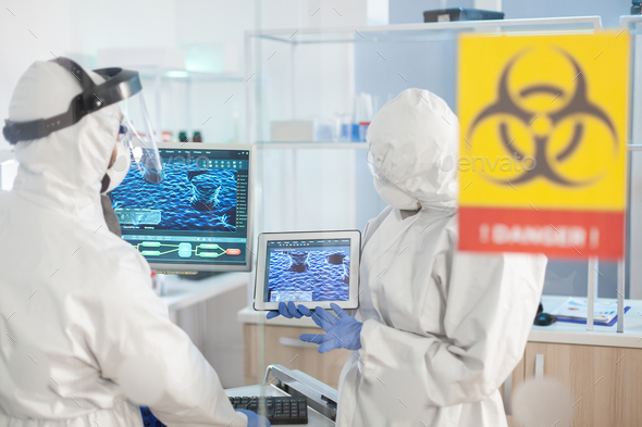 Healthcare doctors working in danger area of lab Stock Photo by DC_Studio