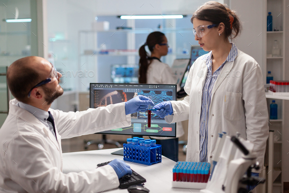 Biochemistry reserarchers doing experiments with blood sample Stock ...