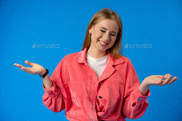 Excited thrilled woman portrait on blue studio background Stock Photo ...