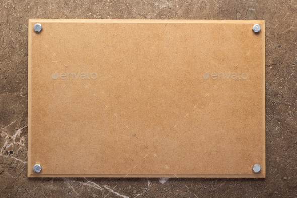 Wooden nameplate or sign board screwed on wall background. Front view ...