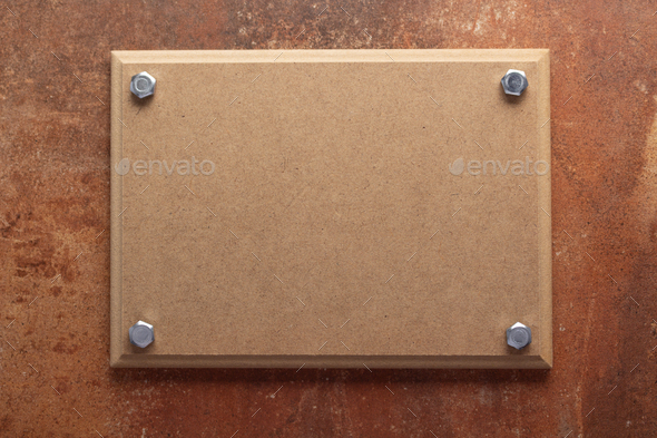 Wooden nameplate or sign board screwed on wall background. Front view ...