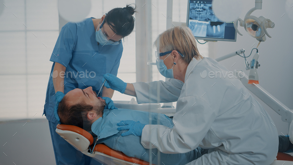 Dentistry team doing teeth consultation to treat patient Stock Photo by ...