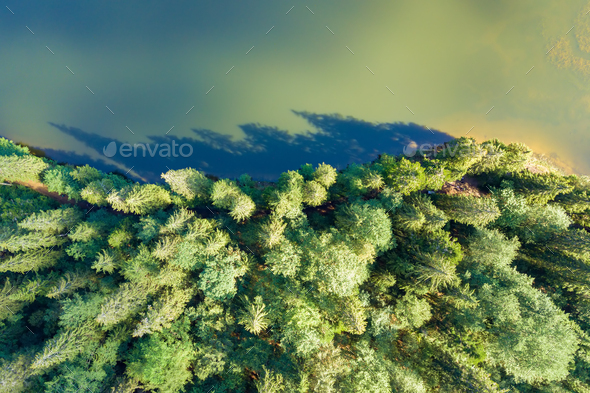 Top down aerial view of big lake with clear blue water between high ...