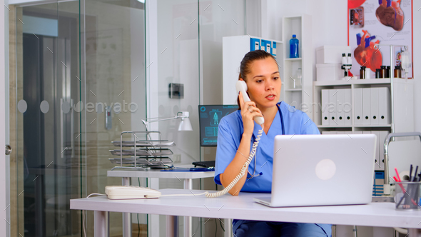 Medical practitioner talking with patient on phone Stock Photo by DC_Studio
