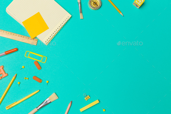 school supplies at colorful paper background Stock Photo by FabrikaPhoto