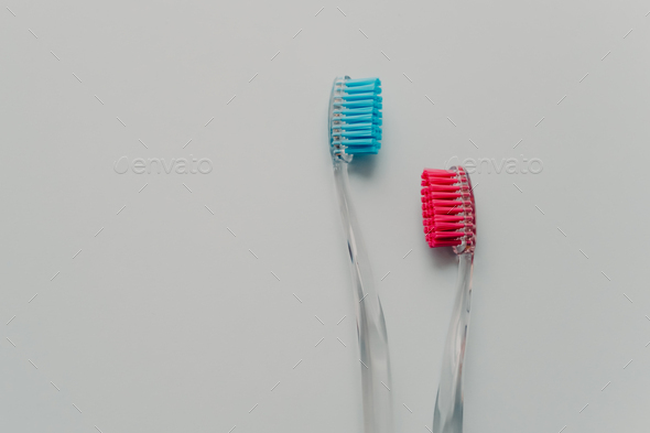 Blue and red plastic toothbrushes isolated over white background ...