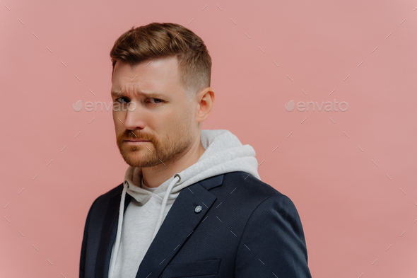 Displeased young man with bristle frowns face has offended look feels ...