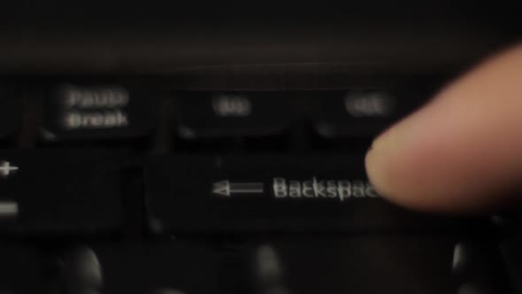 The Finger Presses the Backspace Button on the Keyboard. Close-up ...