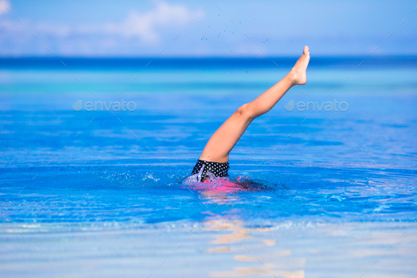 Adorable little girl having fun in outdoor swimming pool Stock Photo by ...