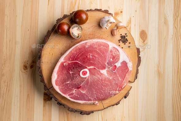 Piece of raw pork ham cut on wooden cutting board, top view Stock Photo ...