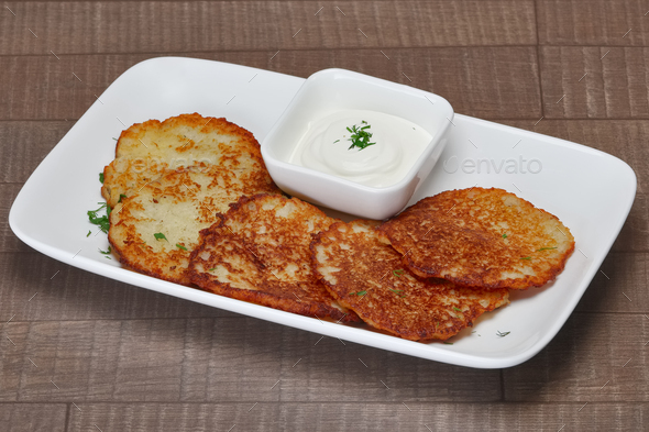 Traditional belorussian potato pancakes with machanka sauce Stock Photo ...