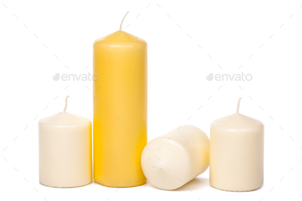 different sized candles on a white background Stock Photo by FabrikaPhoto