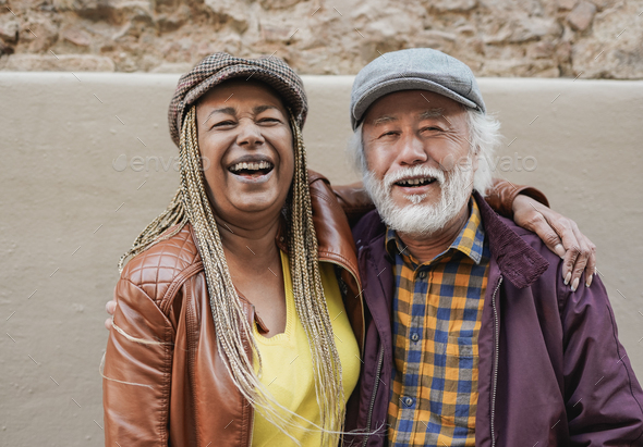 Multiracial senior couple smiling on camera - Diverse elderly people ...