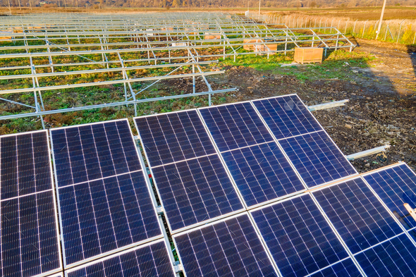 Solar power plant under construction on green field. Assembling of ...