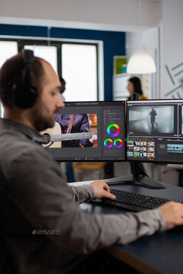 Graphic video production working on pc with two displays editing video ...