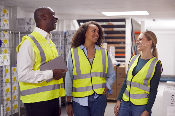 Modern Warehouse With Fulfilment Staff Picking Items From Shelves And ...