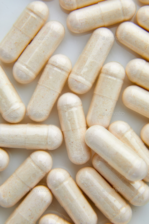 Flat lay macro White beige capsule pills, tablets, top view Stock Photo ...