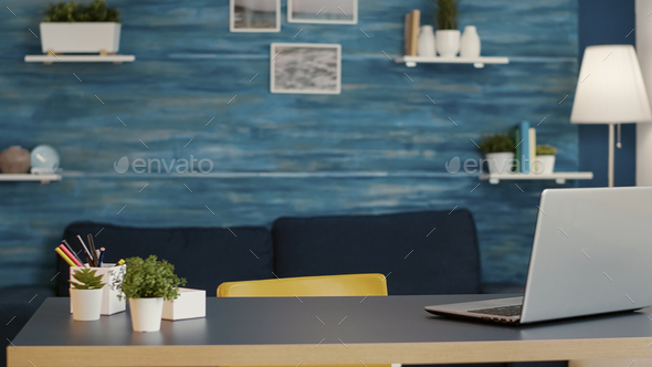 Empty living room and desk with laptop and office supplies Stock Photo ...