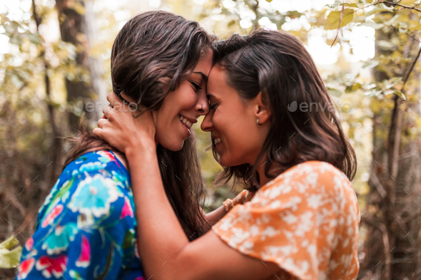 Two young lesbians caressing each other in the woods Stock Photo by ManuReyes