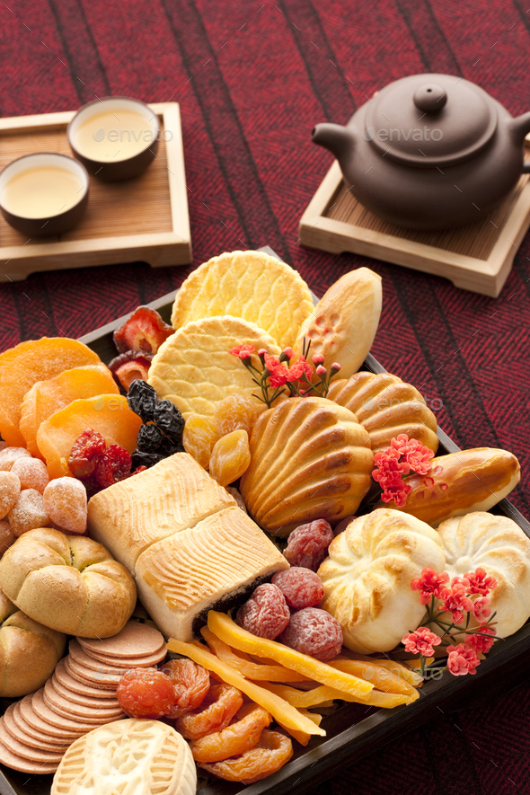 Chinese traditional dim sum and preserved fruits with tea Stock Photo by bluejeanimages