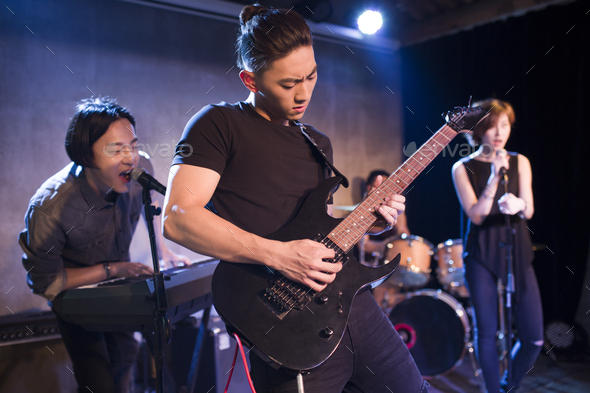 Musical band performing on stage Stock Photo by bluejeanimages | PhotoDune