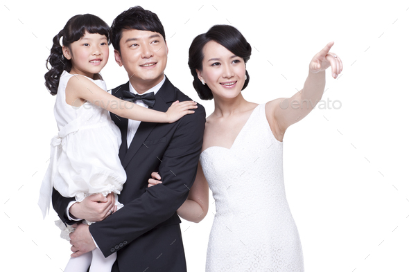 Happy family pointing forward Stock Photo by bluejeanimages | PhotoDune