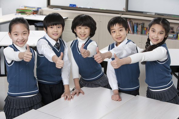 Five excited students in the classroom Stock Photo by bluejeanimages