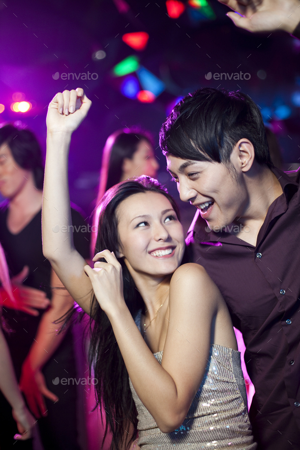 Stylish young people dancing in nightclub Stock Photo by bluejeanimages