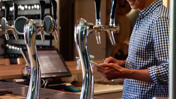Bar tender using digital tablet at counter 4k, Stock Footage | VideoHive