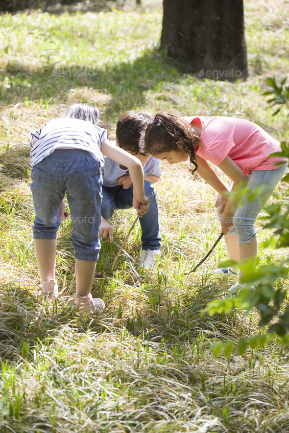 Happy children playing in woods Stock Photo by bluejeanimages | PhotoDune