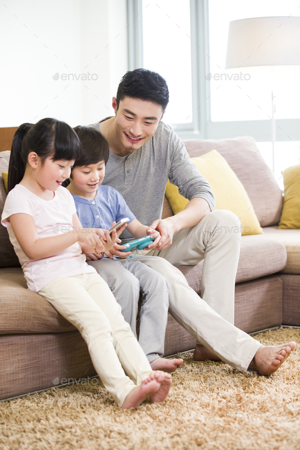 Father and kids playing video game Stock Photo by bluejeanimages ...