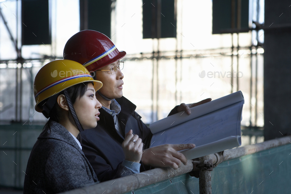 Businesspeople In Construction Site Wearing Hard Hats Stock Photo by ...