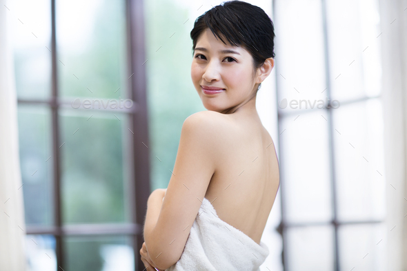 Rear view of young woman wrapped in towel in a luxury hotel Stock Photo ...