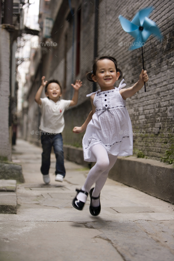 Children run with a paper pinwheel Stock Photo by bluejeanimages ...