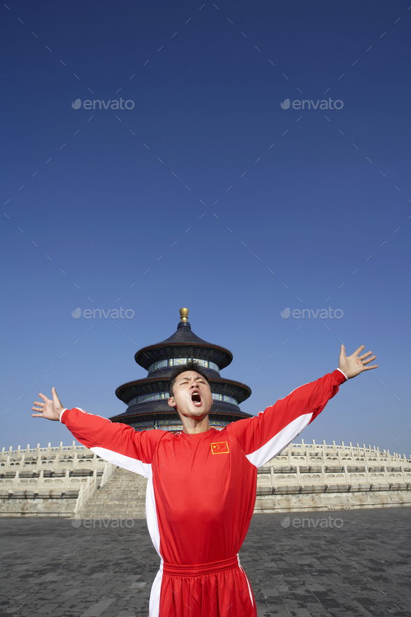 Young Male Soccer Player Yelling In Front Of Temple Stock Photo by ...