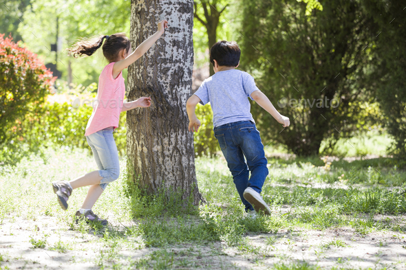 Happy children playing in woods Stock Photo by bluejeanimages | PhotoDune