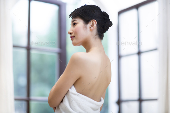 Rear view of young woman wrapped in towel in a luxury hotel Stock Photo ...