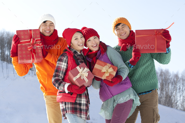 Young people holding gift boxes Stock Photo by bluejeanimages | PhotoDune
