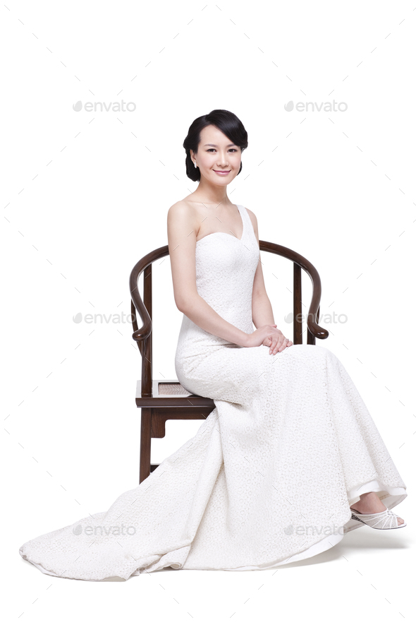Elegant young woman sitting on Chinese Ming-style wooden armchair Stock ...