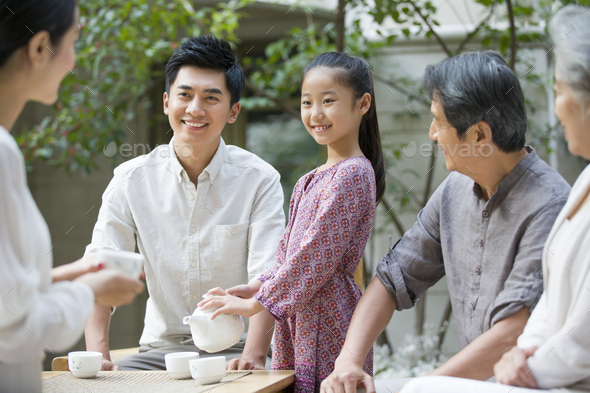 Happy family drinking tea together Stock Photo by bluejeanimages ...